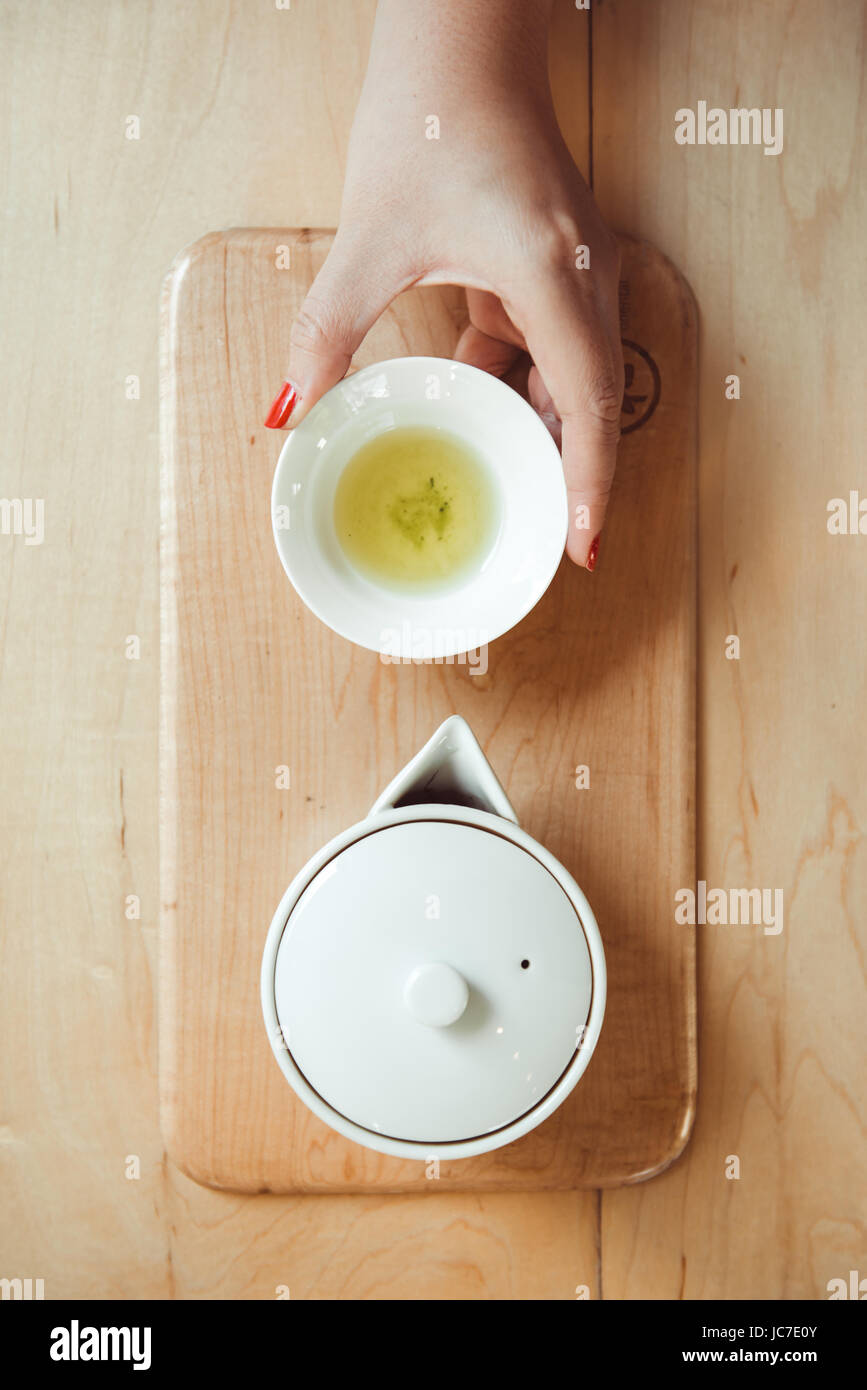 Hands holding Japanese Sencha Tea in clay pot Stock Photo - Alamy