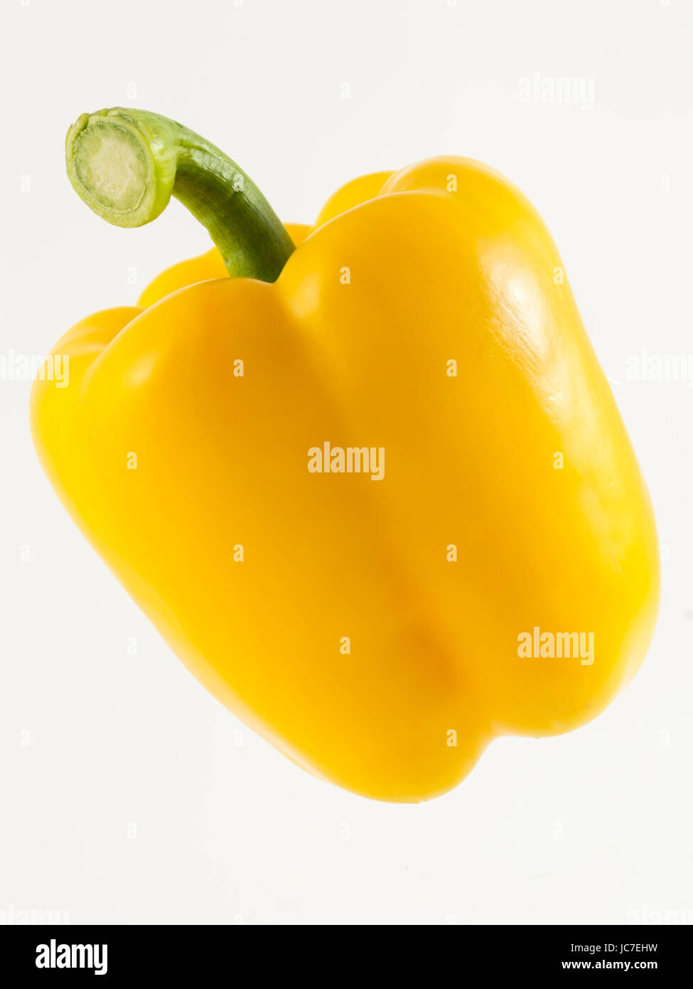 One pepper yellow on white background Stock Photo - Alamy