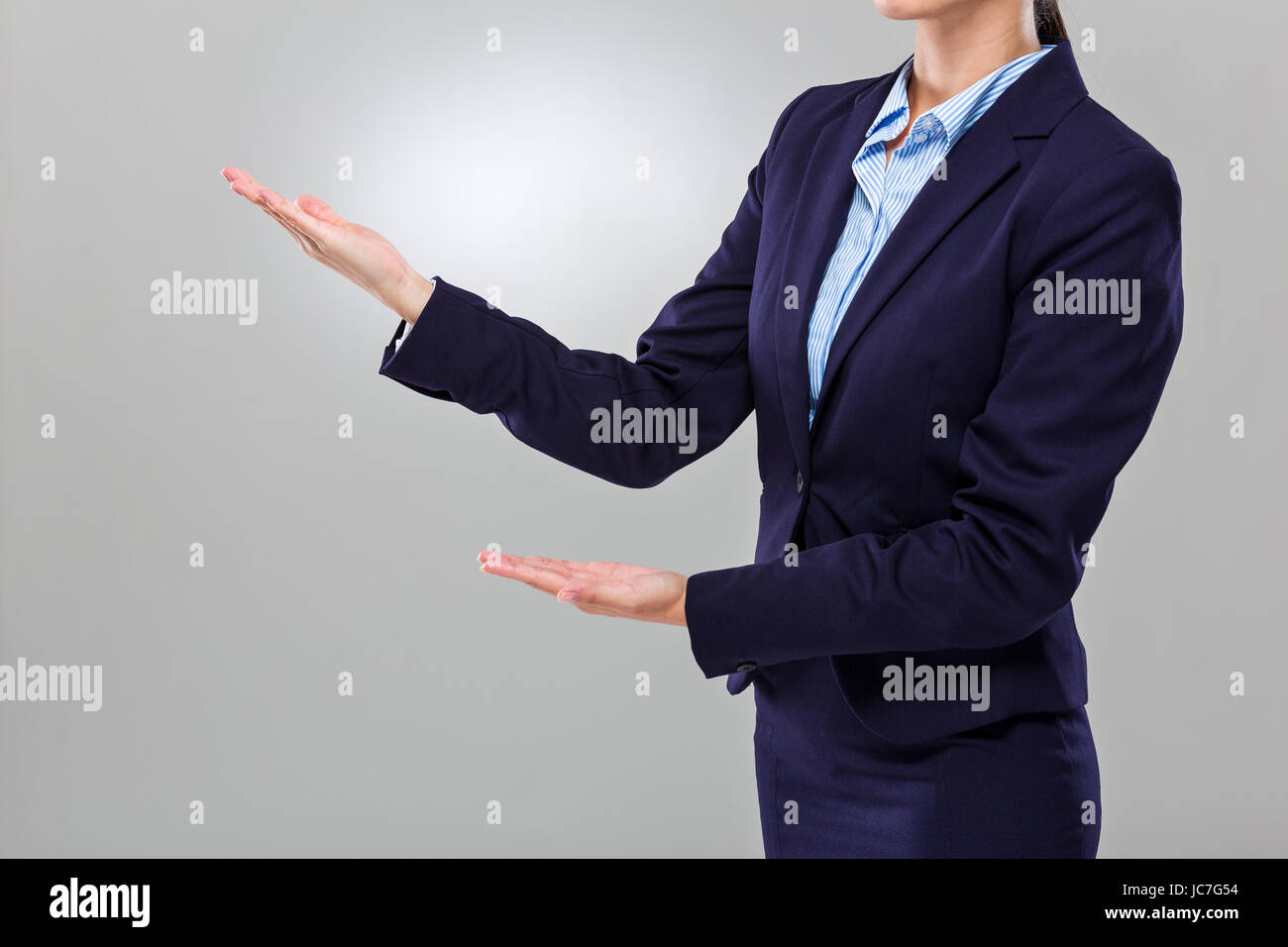 Businesswoman with two hand presentation Stock Photo - Alamy