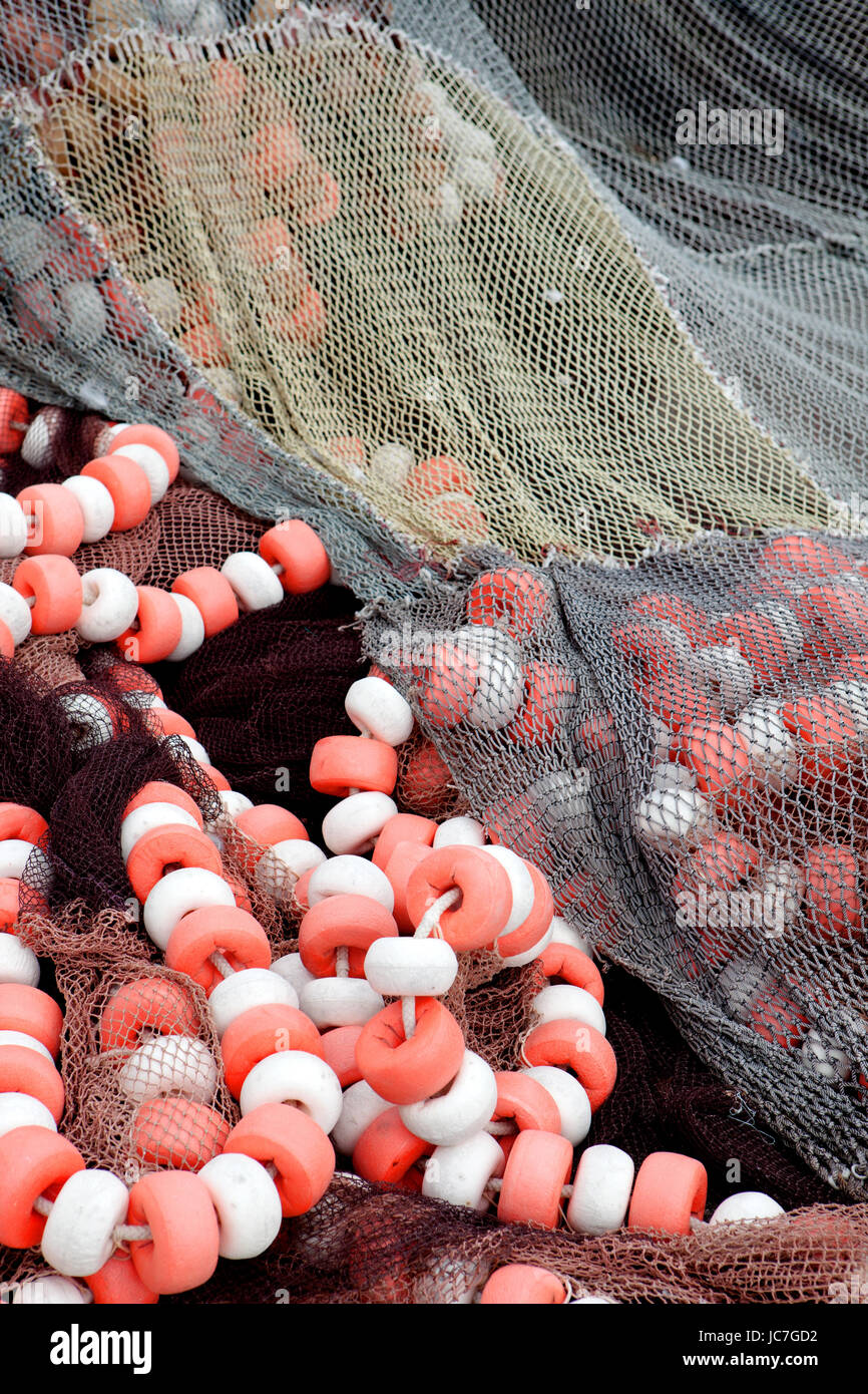 Fishing nets stacked waiting to return to sea Stock Photo - Alamy
