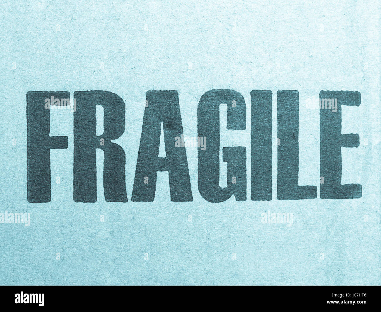 Fragile warning sign label tag on a cardboard box packet parcel for mail post shipping - cool ...