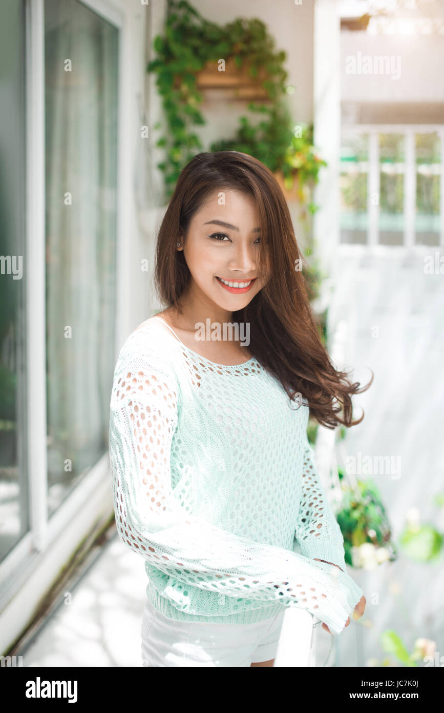 Asian woman enjoying fresh air at home Stock Photo - Alamy