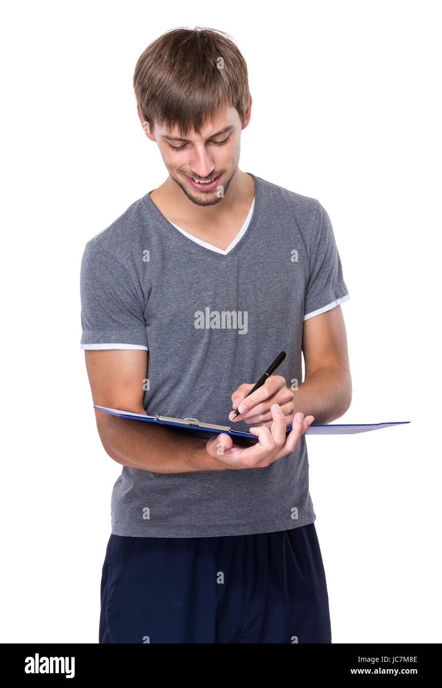 Caucasian man write on clipboard Stock Photo - Alamy