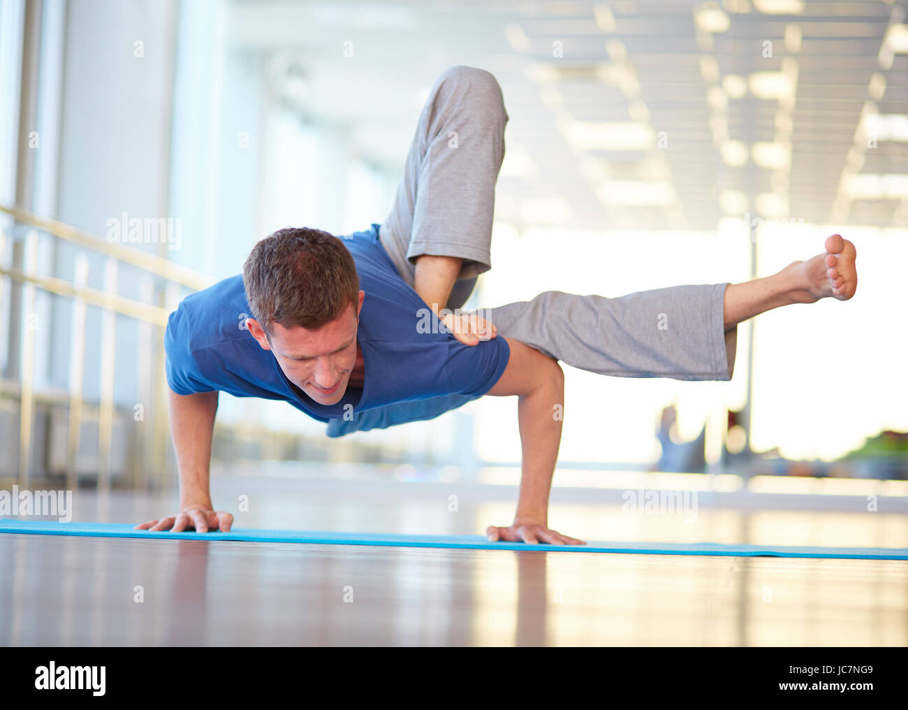 Skilled guy doing physical exercise in gym Stock Photo - Alamy