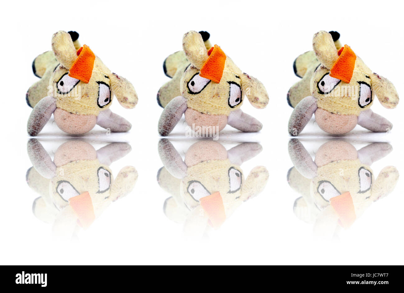 Hand made kids toy and its reflection isolated on white. less is more ...