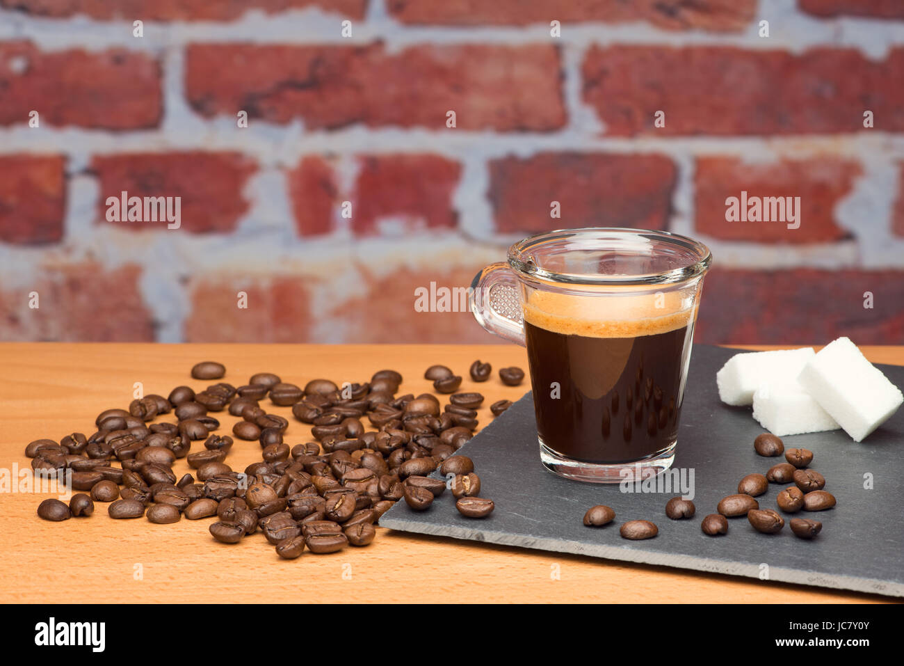 Cup of coffee on brick wall Stock Photo - Alamy