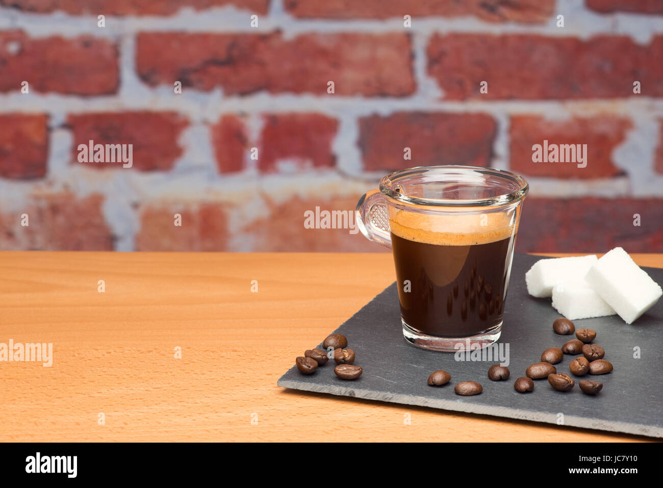 Cup of coffee on brick wall Stock Photo - Alamy