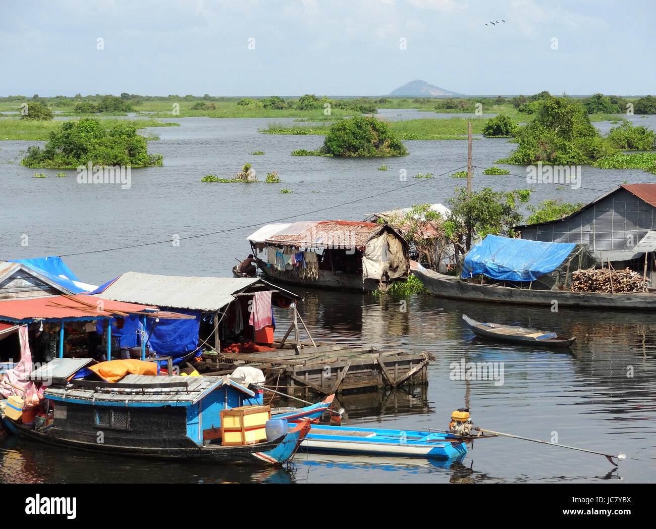 waterside scenery with rural houses and boats at the Tonle Sap, a river ...