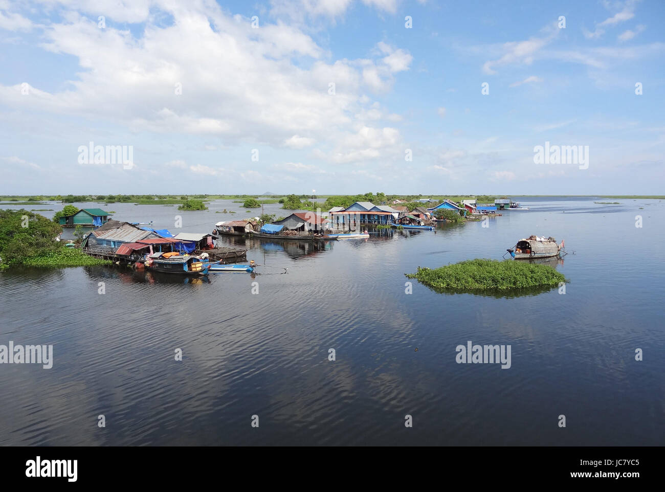 waterside scenery with rural houses and boats at the Tonle Sap, a river ...