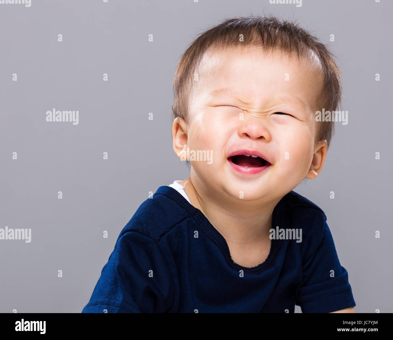 Baby boy winking eye Stock Photo - Alamy
