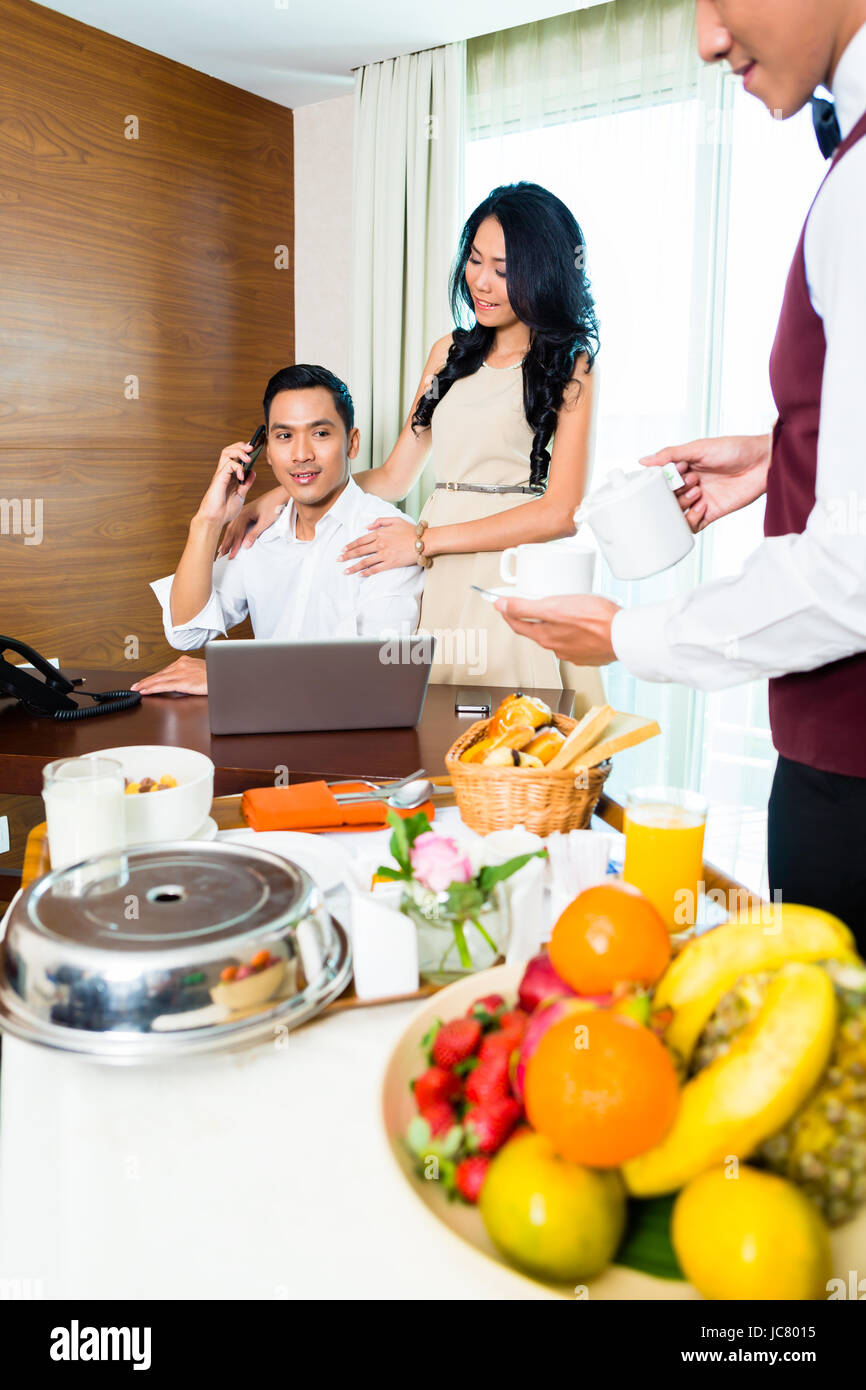 Asian room service waiter serving breakfast in hotel room Stock Photo ...