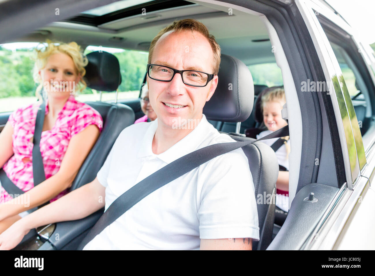 Family driving in car with seat belt fastened Stock Photo - Alamy