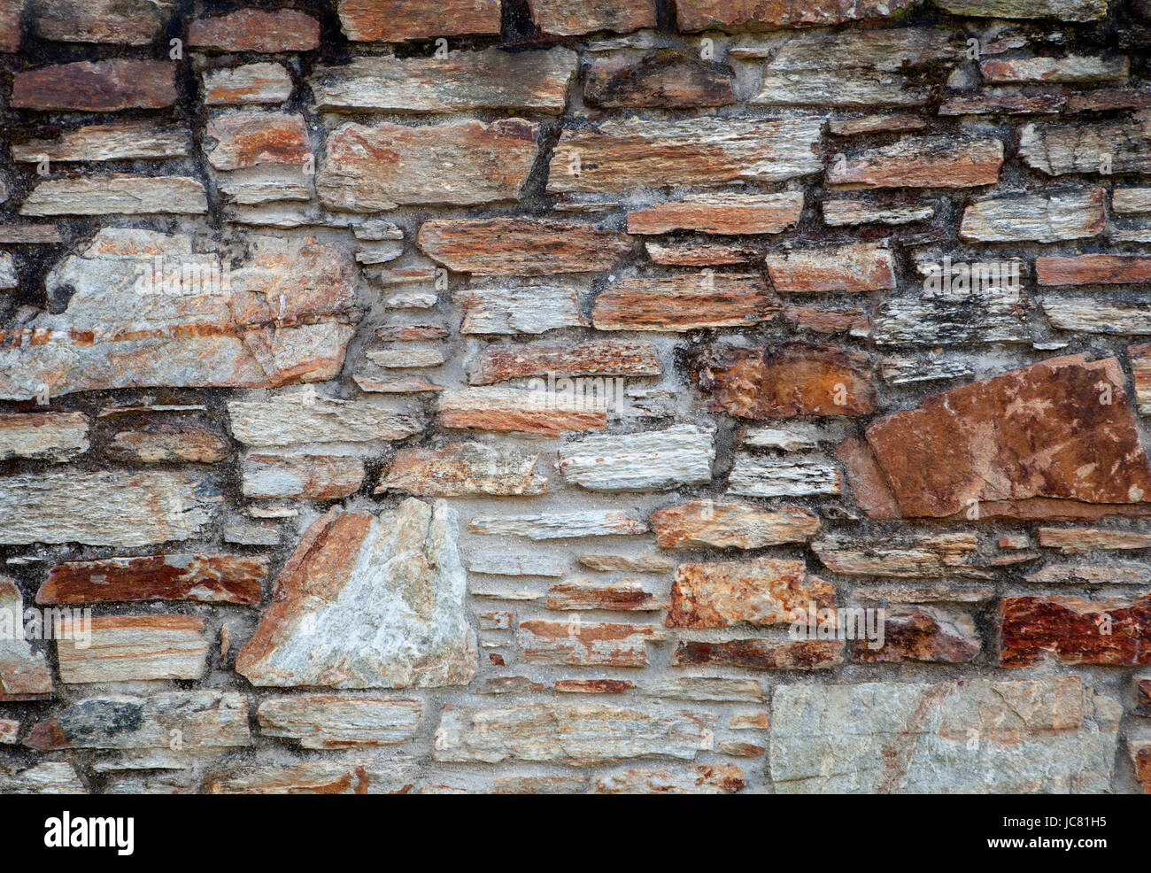 Aged stone wall by the time Stock Photo - Alamy