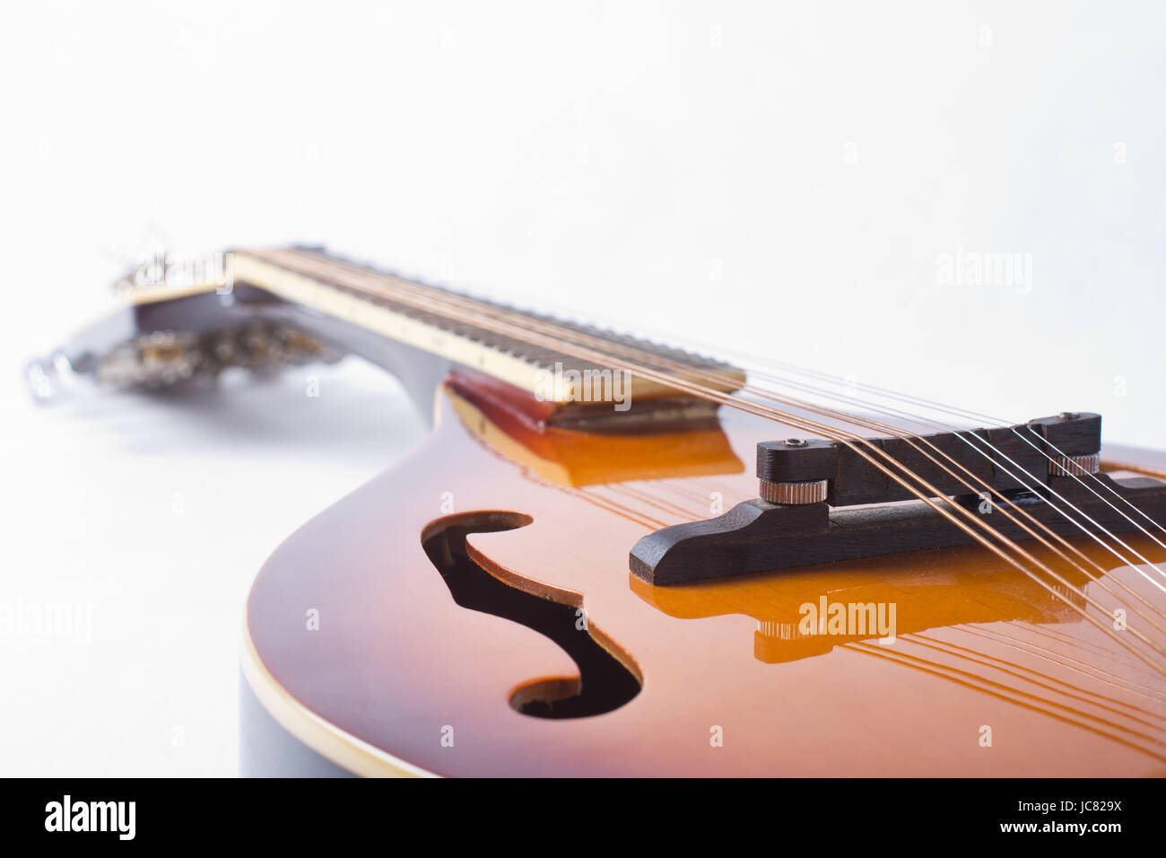 Detail photo of bluegrass mandolin on white background Stock Photo - Alamy