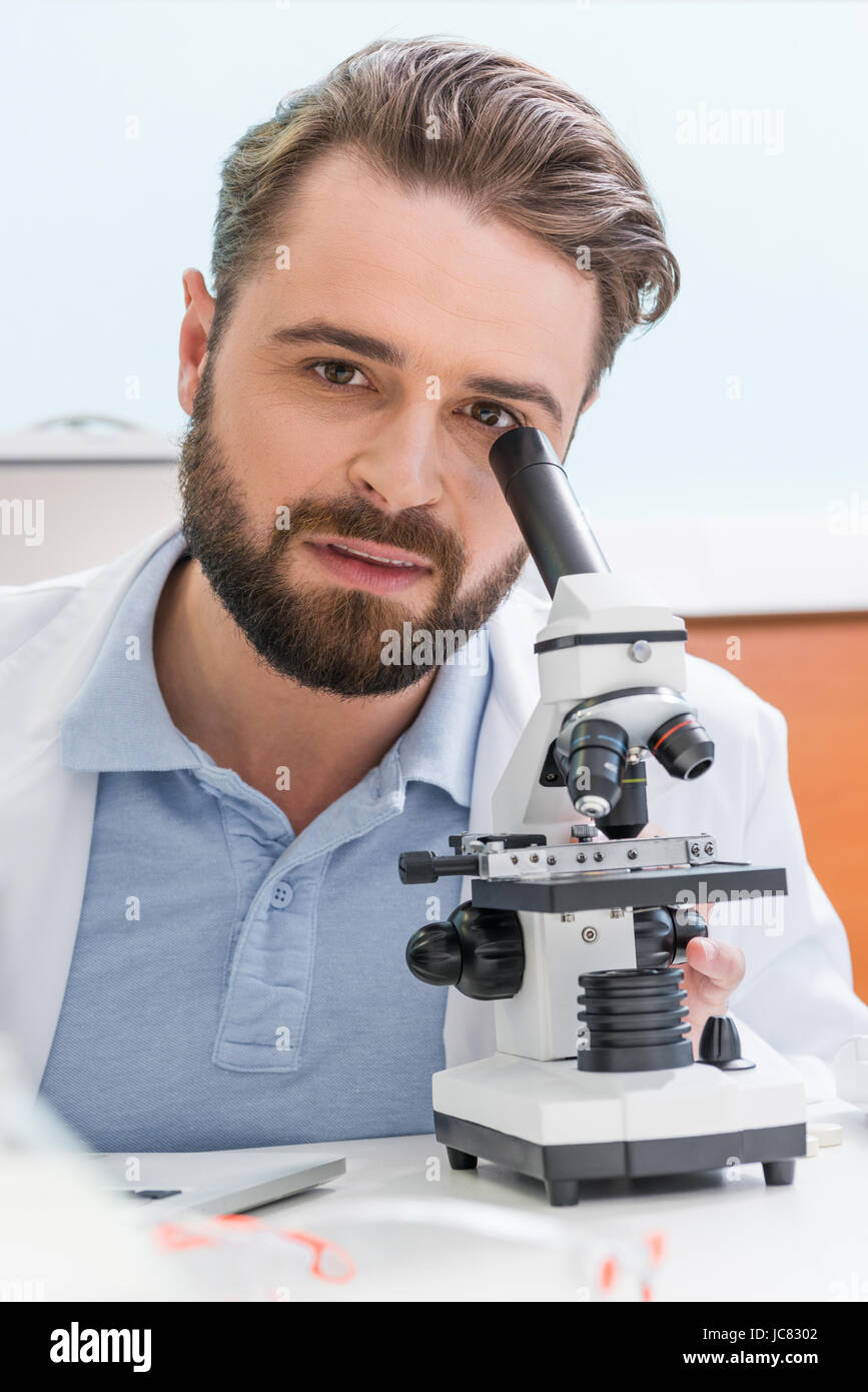 Scientist work looking in microscope hi-res stock photography and ...