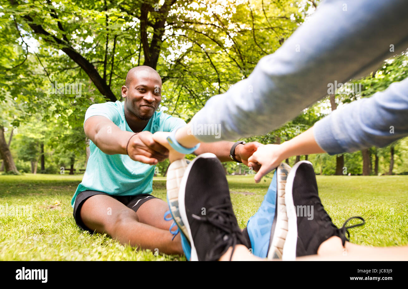 Holding hands couple stretching hi-res stock photography and images - Alamy