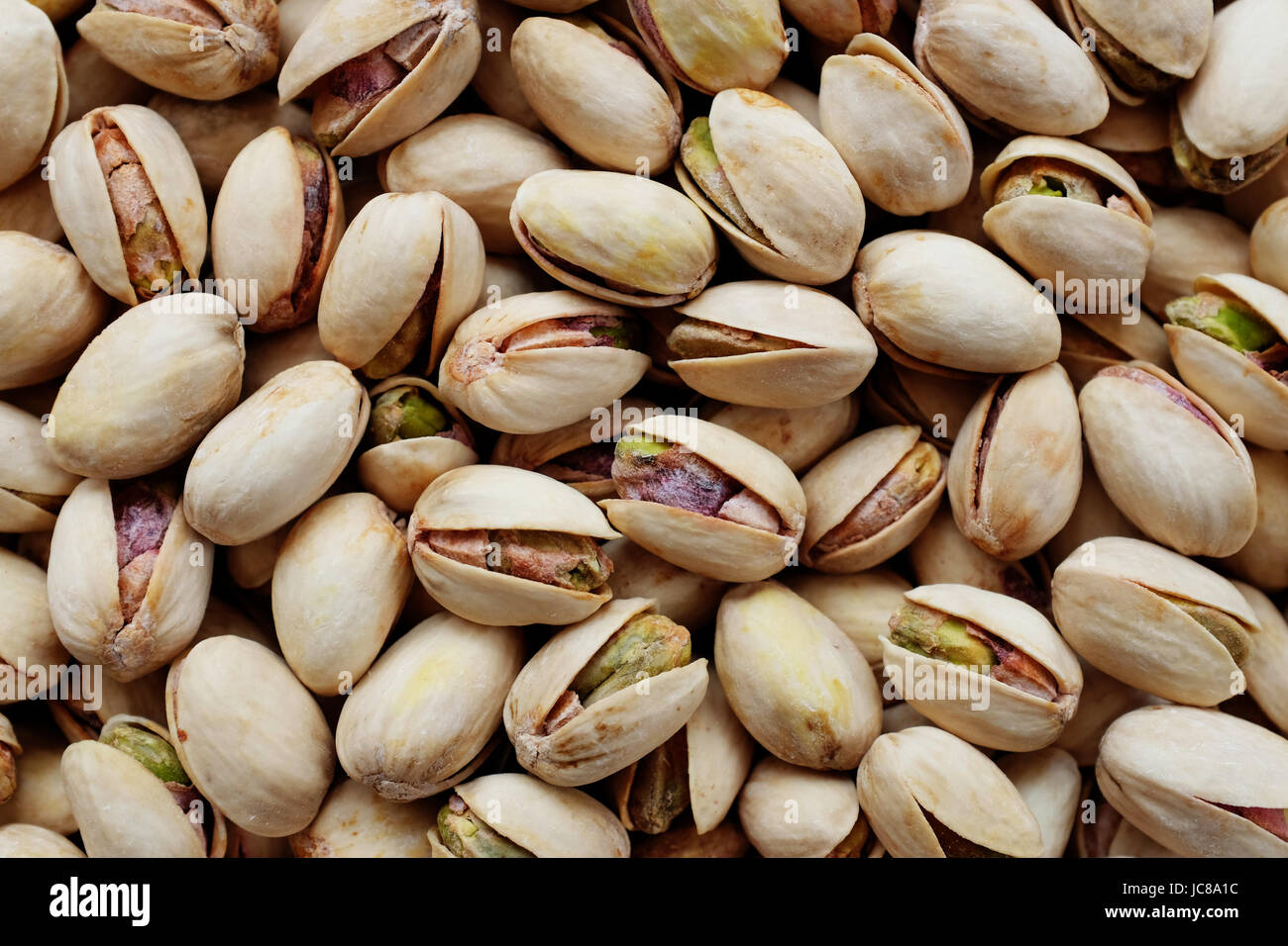 Roasted and salted pistachios in their shells as an abstract background texture Stock Photo - Alamy