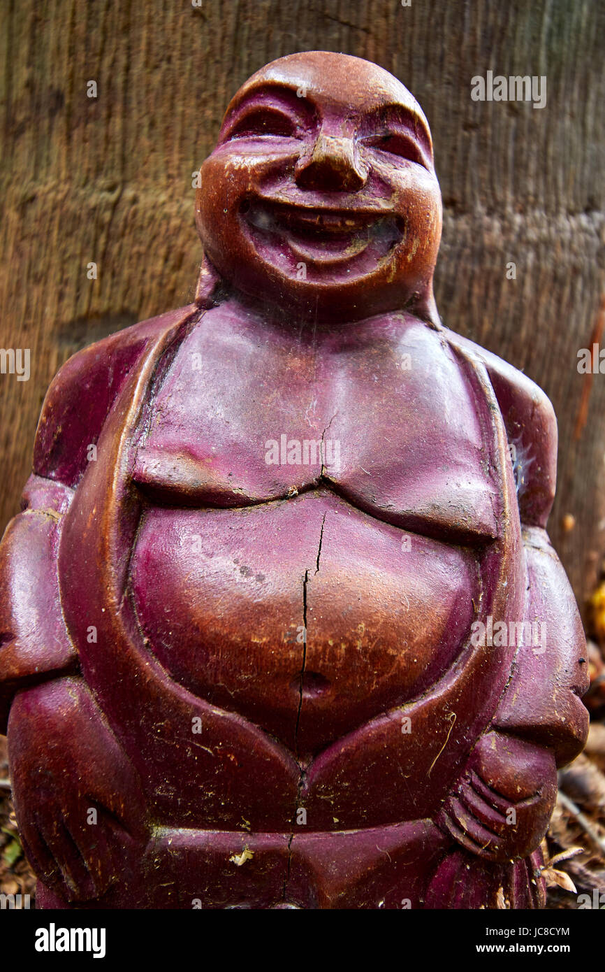 Red Buddha by coconut tree Stock Photo - Alamy