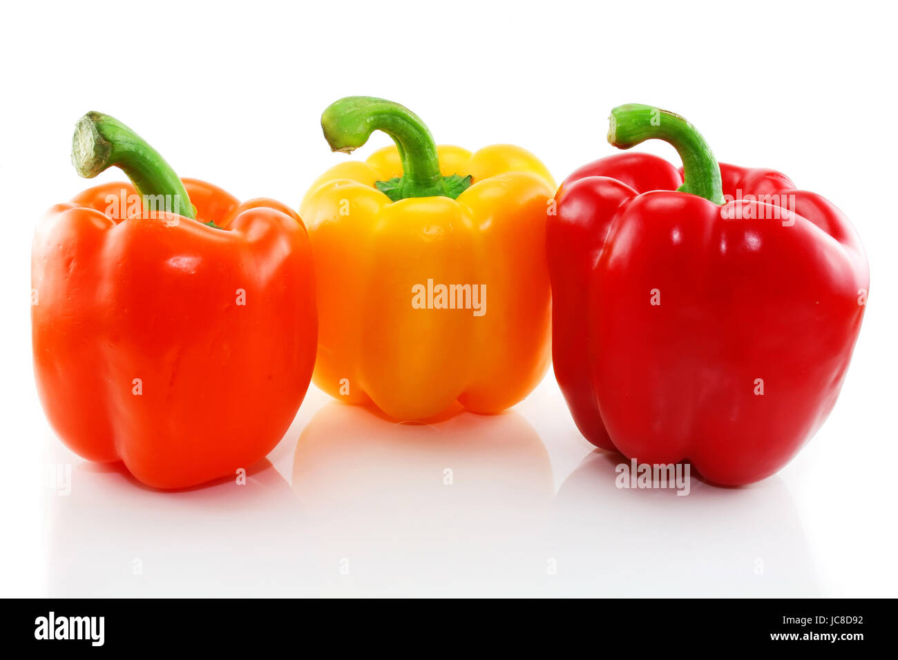 Three colored paprika isolated on a white background Stock Photo - Alamy