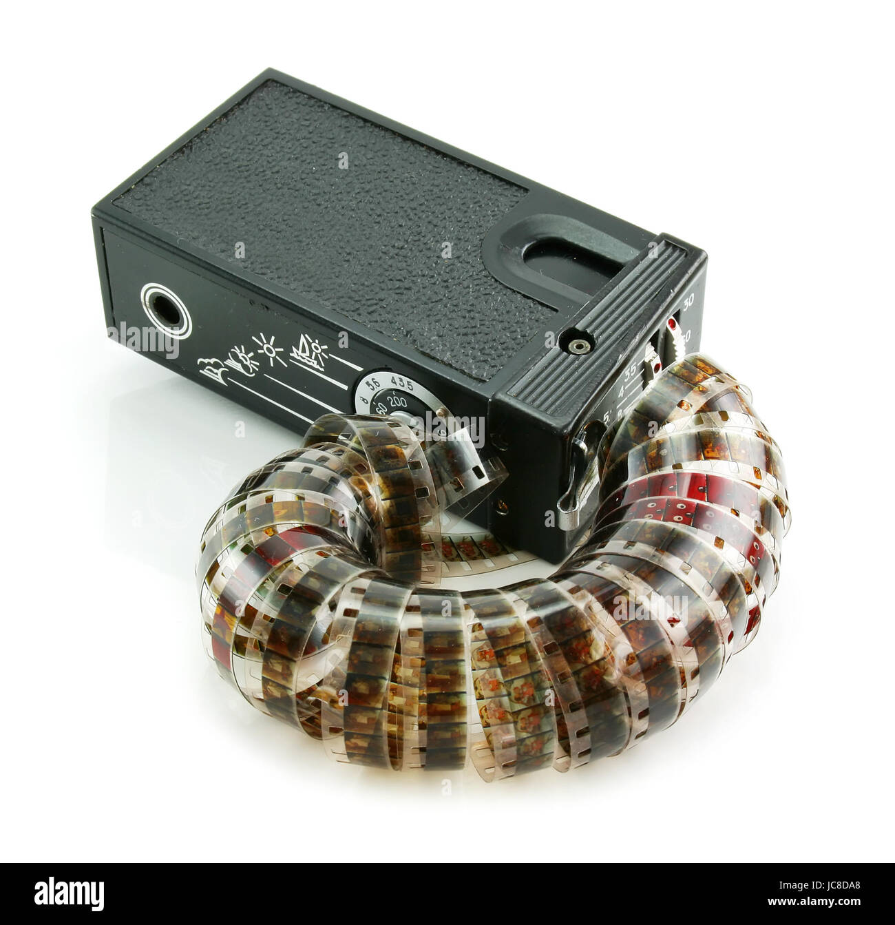 Small espionage photo camera and film isolated on a white background ...