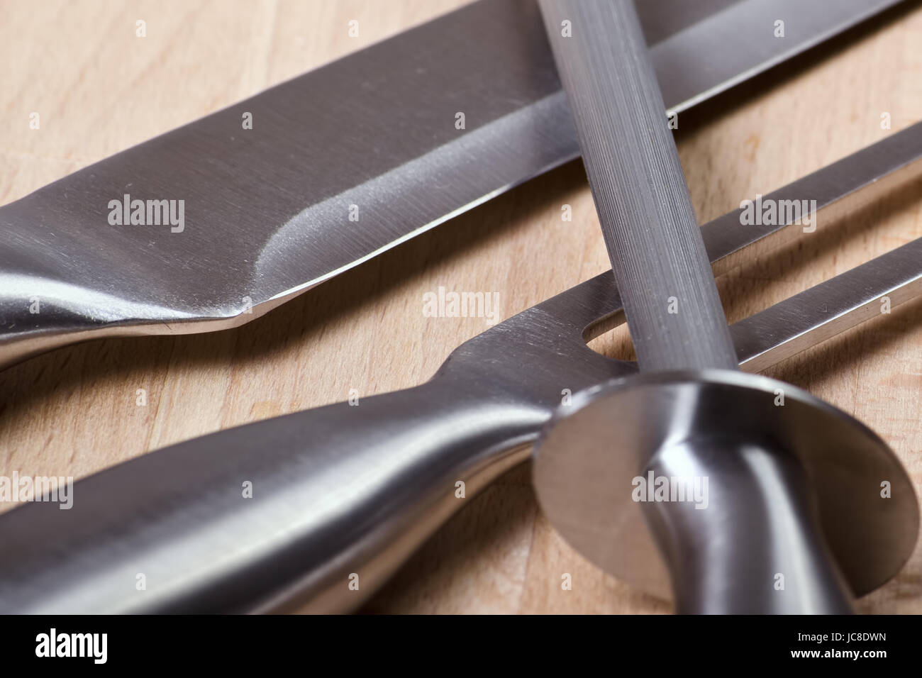metallic sharp kitchen instruments on cuting board made of wood Stock ...
