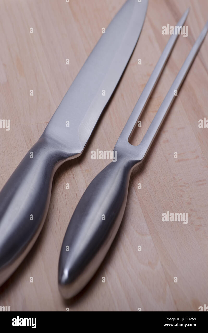 metallic sharp kitchen instruments on cuting board made of wood Stock ...