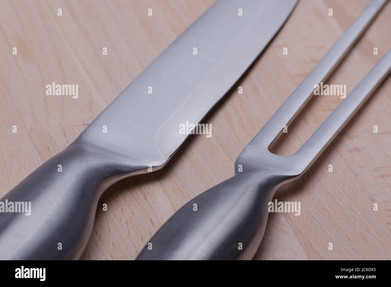 metallic sharp kitchen instruments on cuting board made of wood Stock ...