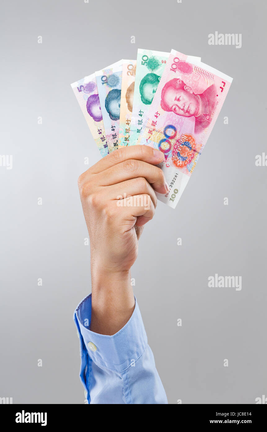 Businessman hand hold different chinese banknote Stock Photo - Alamy