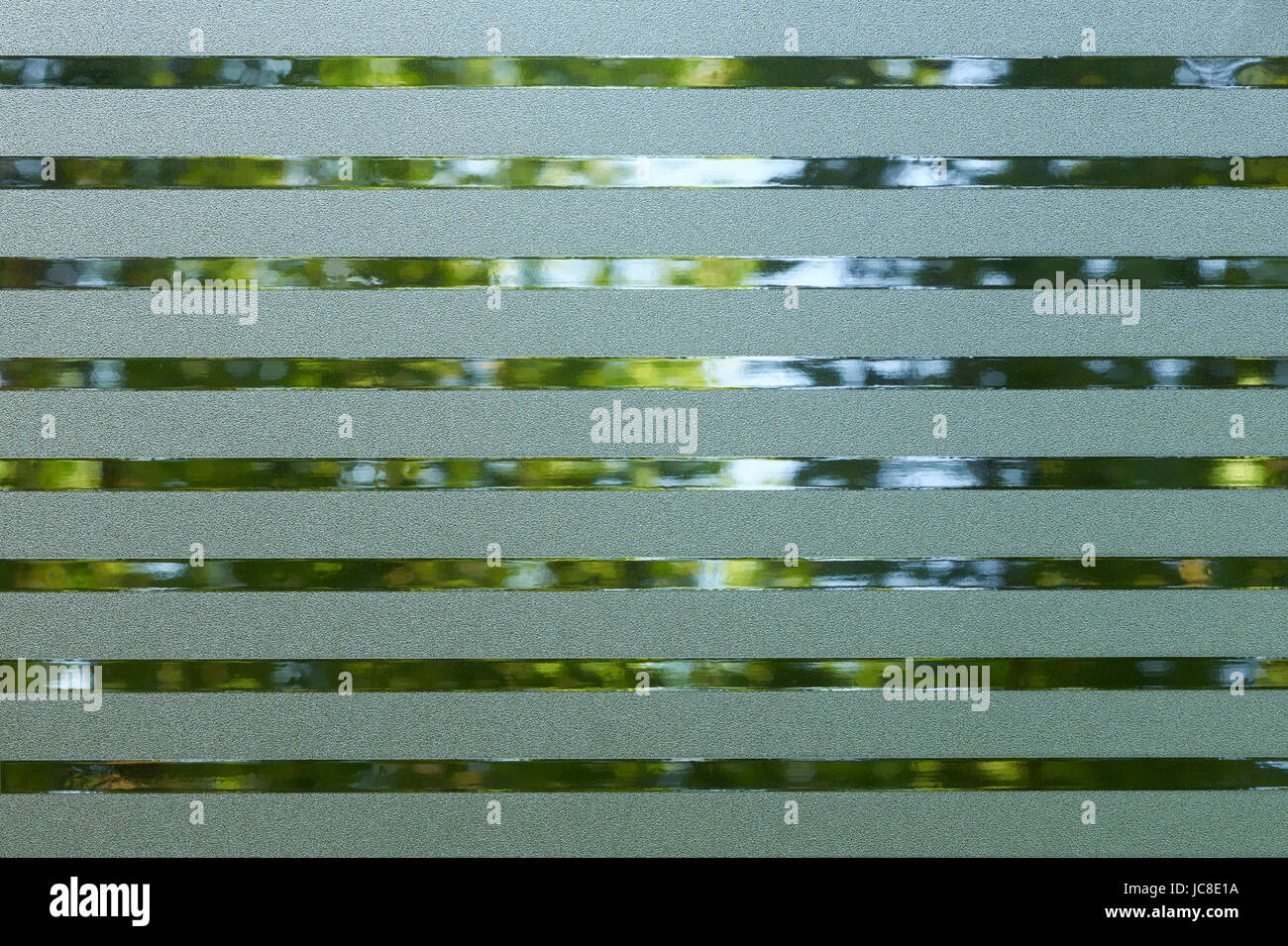 full frame abstract blue green lined translucent plastic foil in front ...