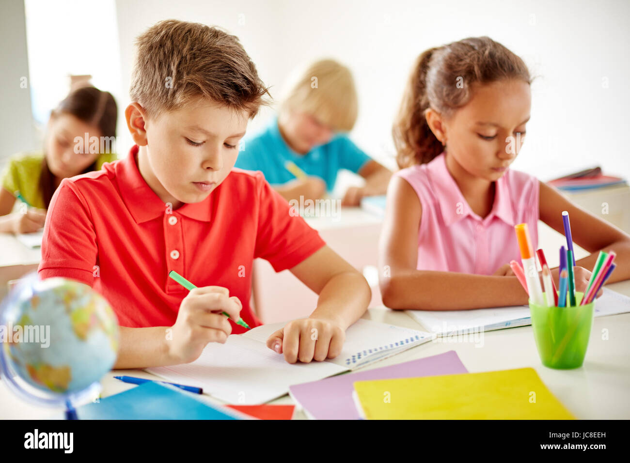 Several classmates drawing at lesson Stock Photo - Alamy