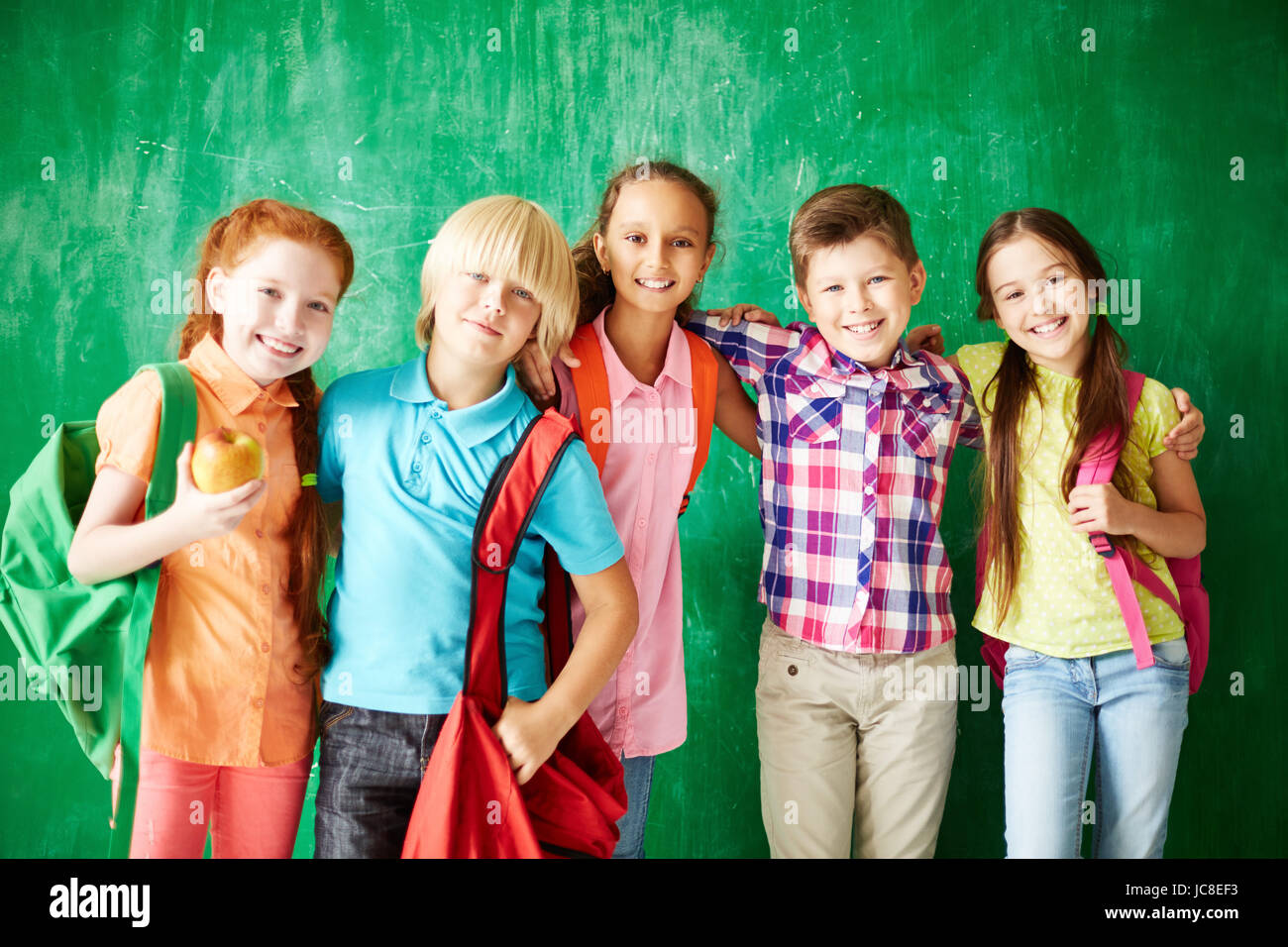 Portrait of friendly classmates looking at camera with smiles Stock ...