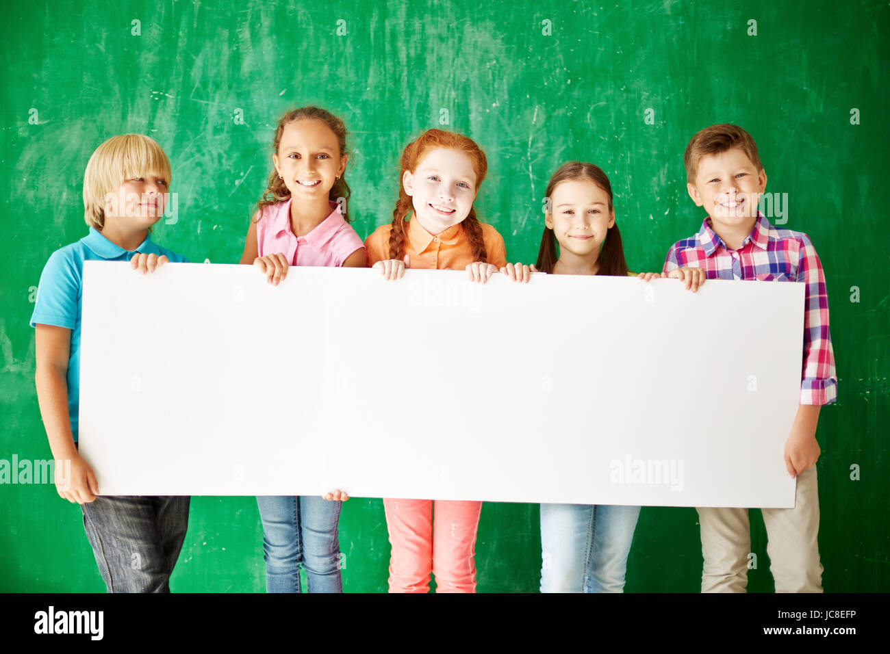 Friendly classmates with blank paper Stock Photo - Alamy