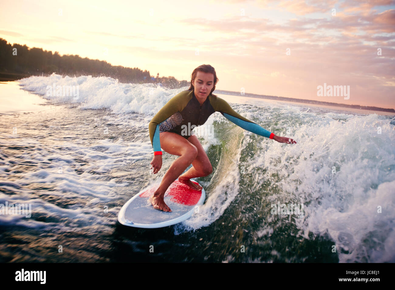 Pretty girl surfboarding in the sea at summer resort Stock Photo - Alamy