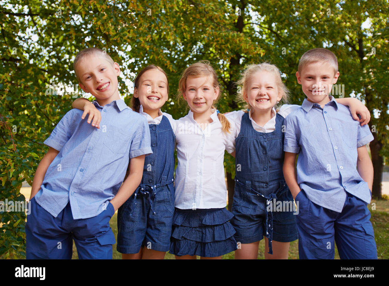 Portrait of friendly pupils looking at camera outside Stock Photo - Alamy