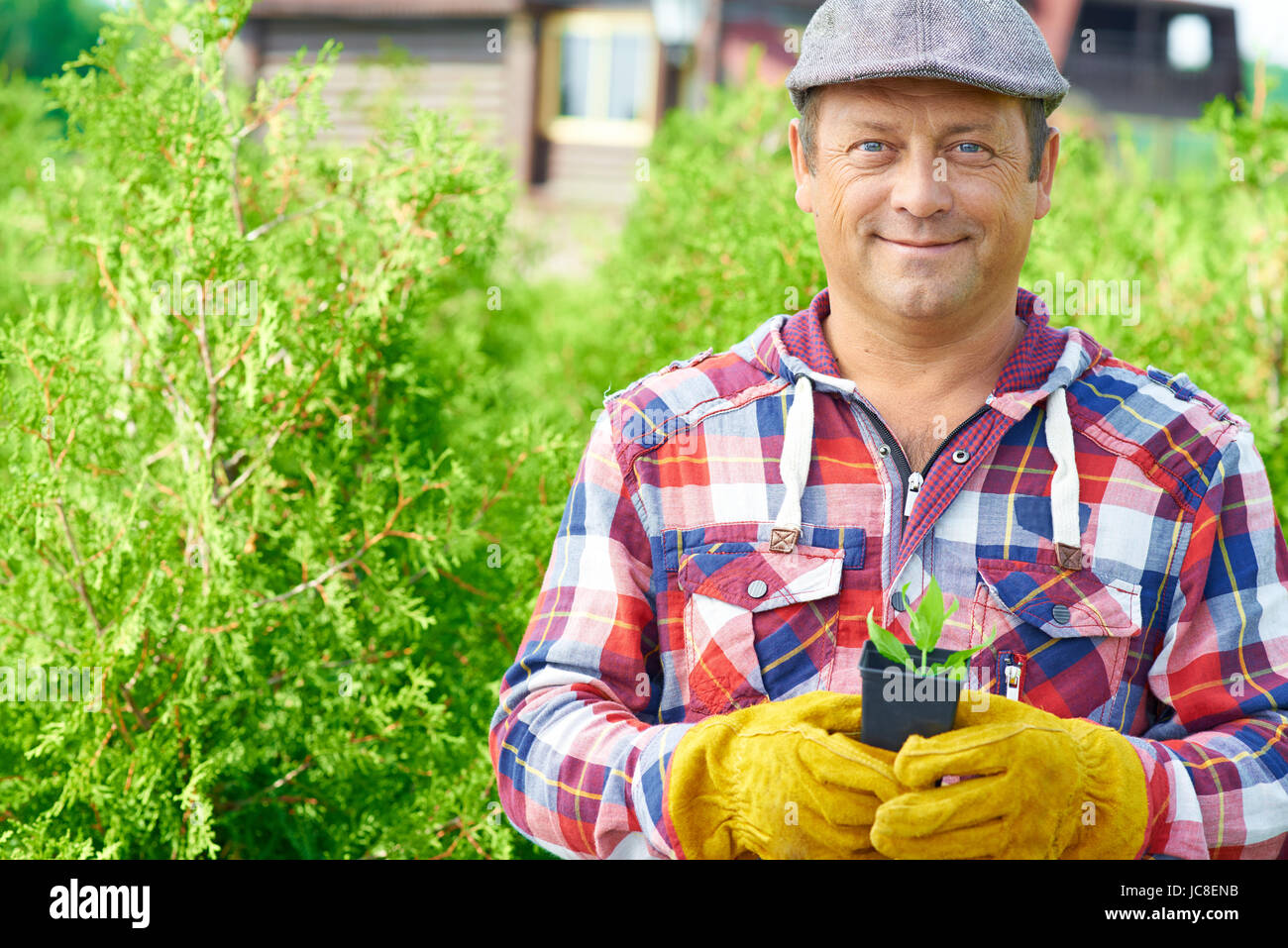 Happy handsome gardener looking camera hi-res stock photography and ...
