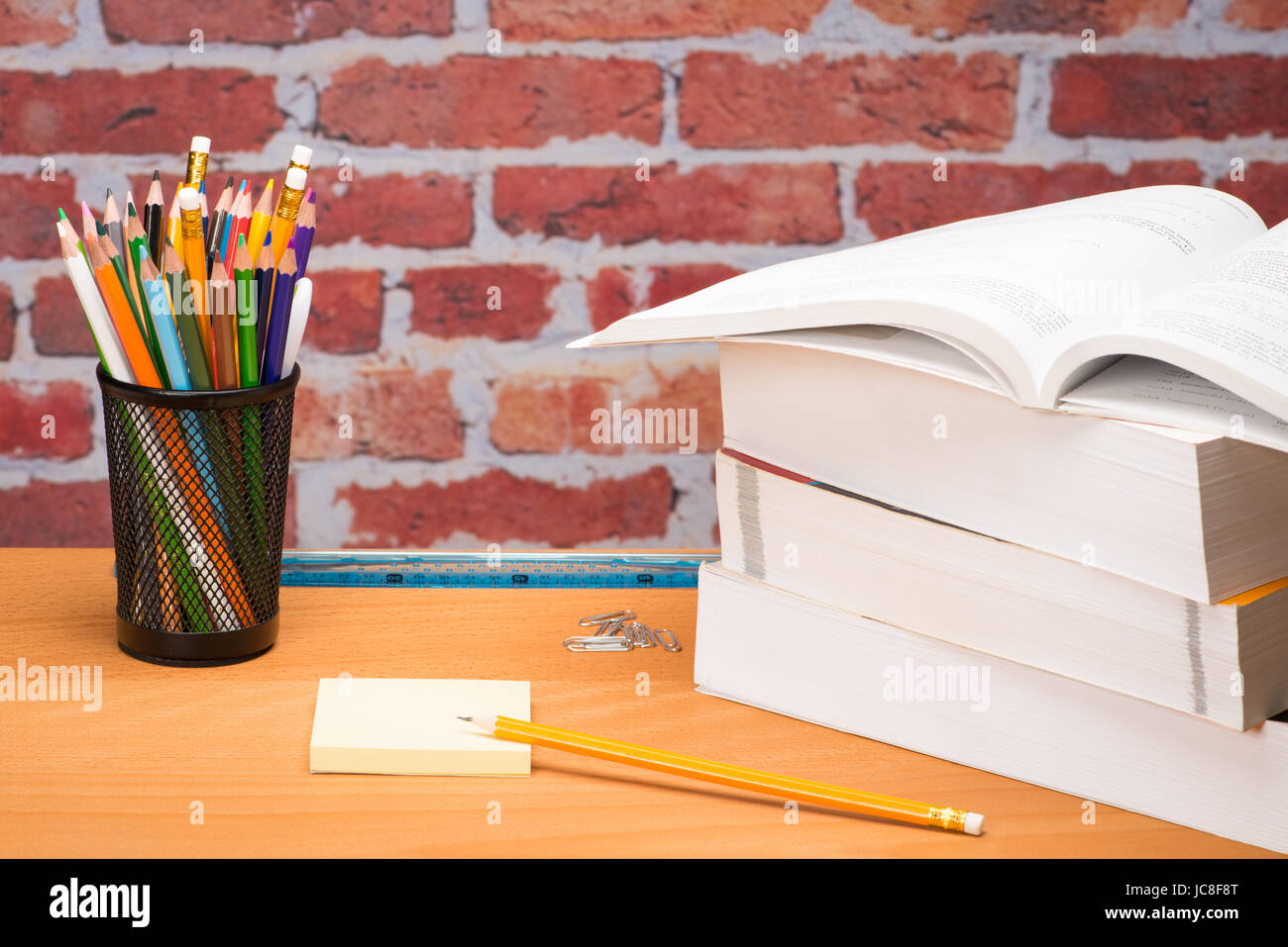 School supplies with adhesive note in front of brick wall Stock Photo ...