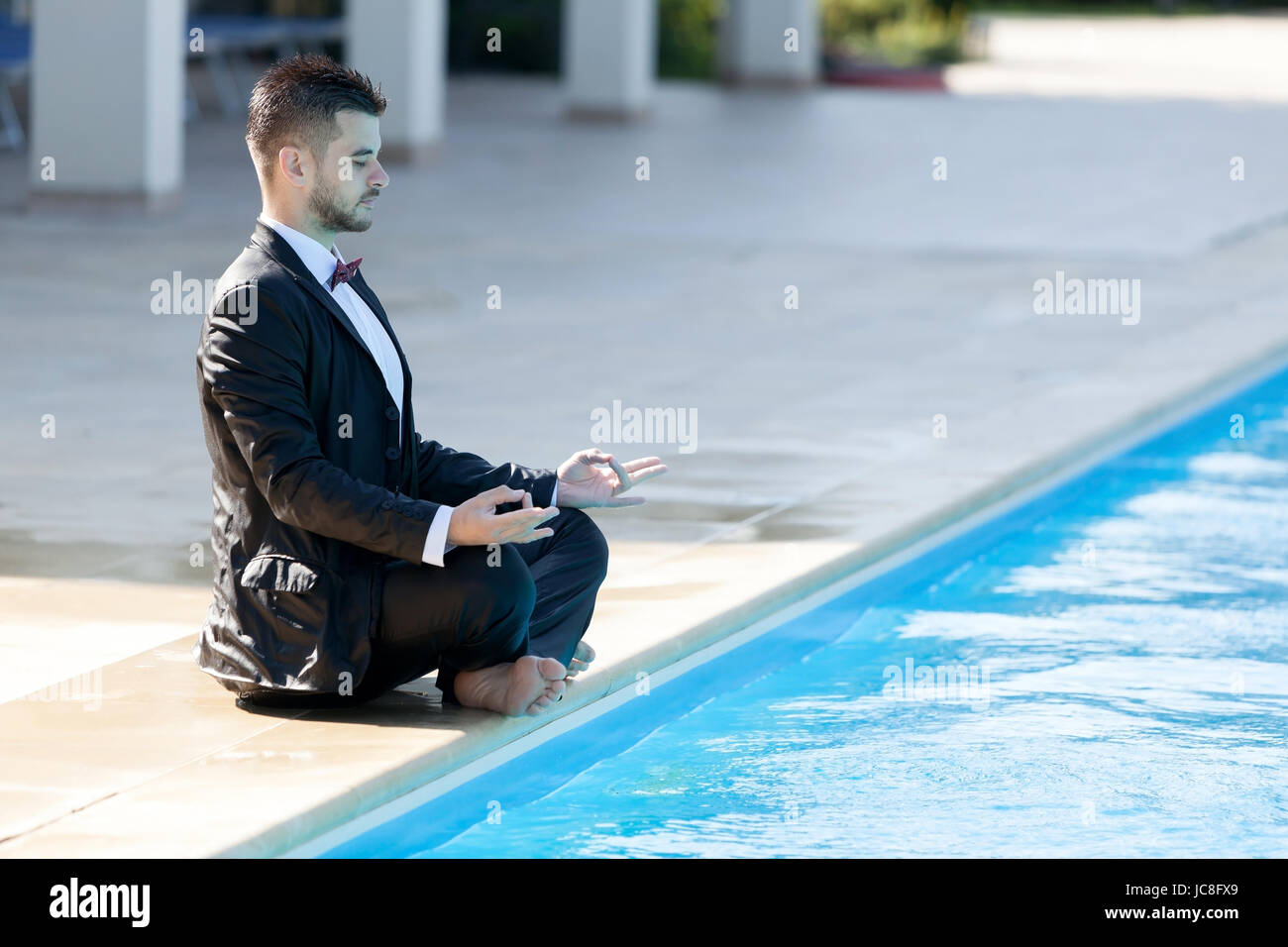 Businessman enjoying the relaxing time in the pool with suit on Stock ...