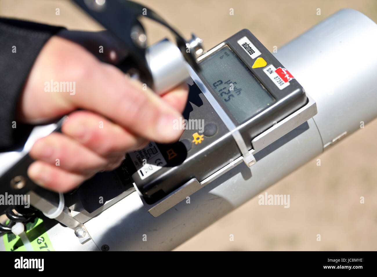 A person measures the radiation exposure with a local dose measuring ...