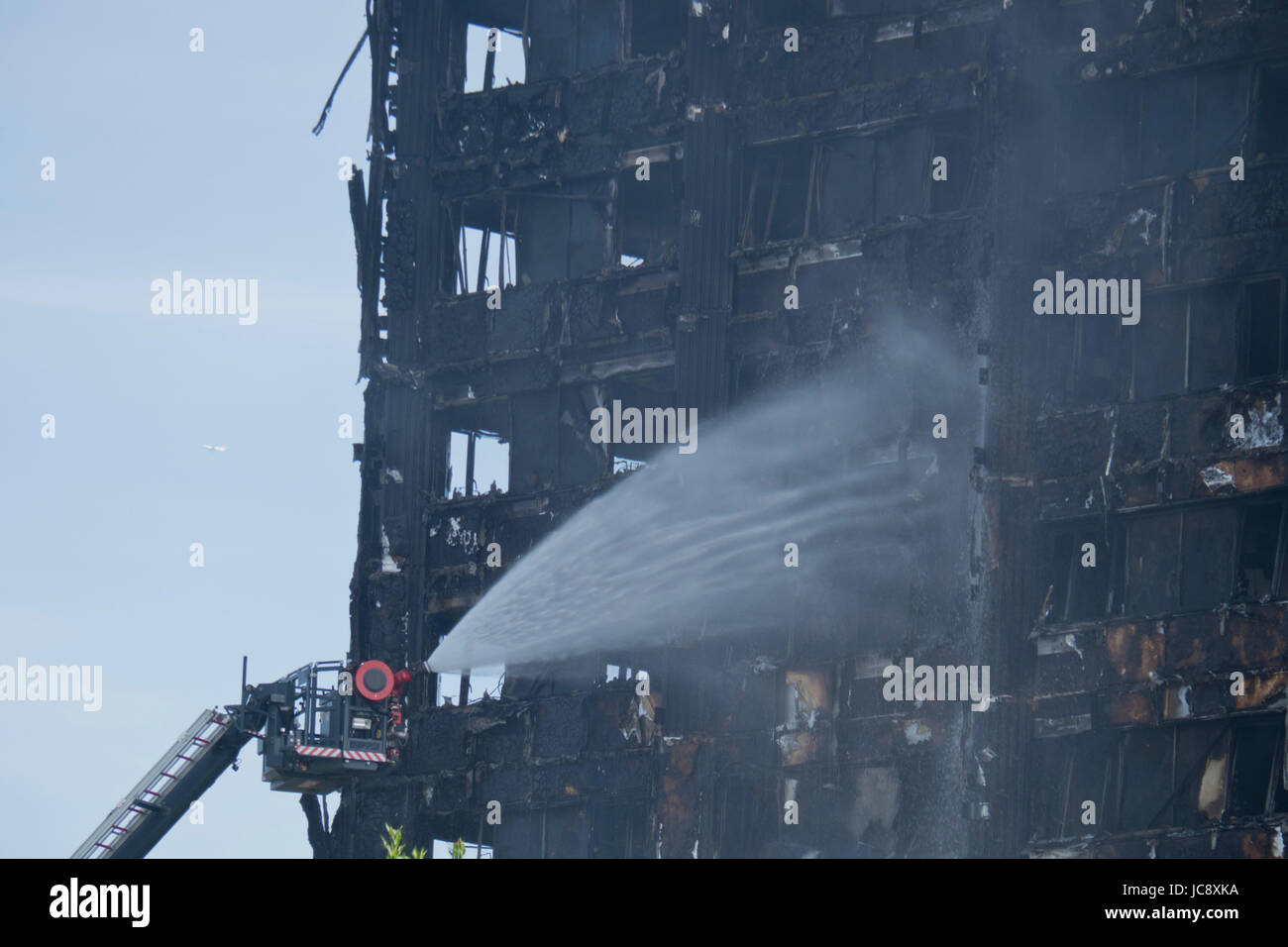 London, UK. 14th June, 2017. View of fire brigade pouring water on to ...