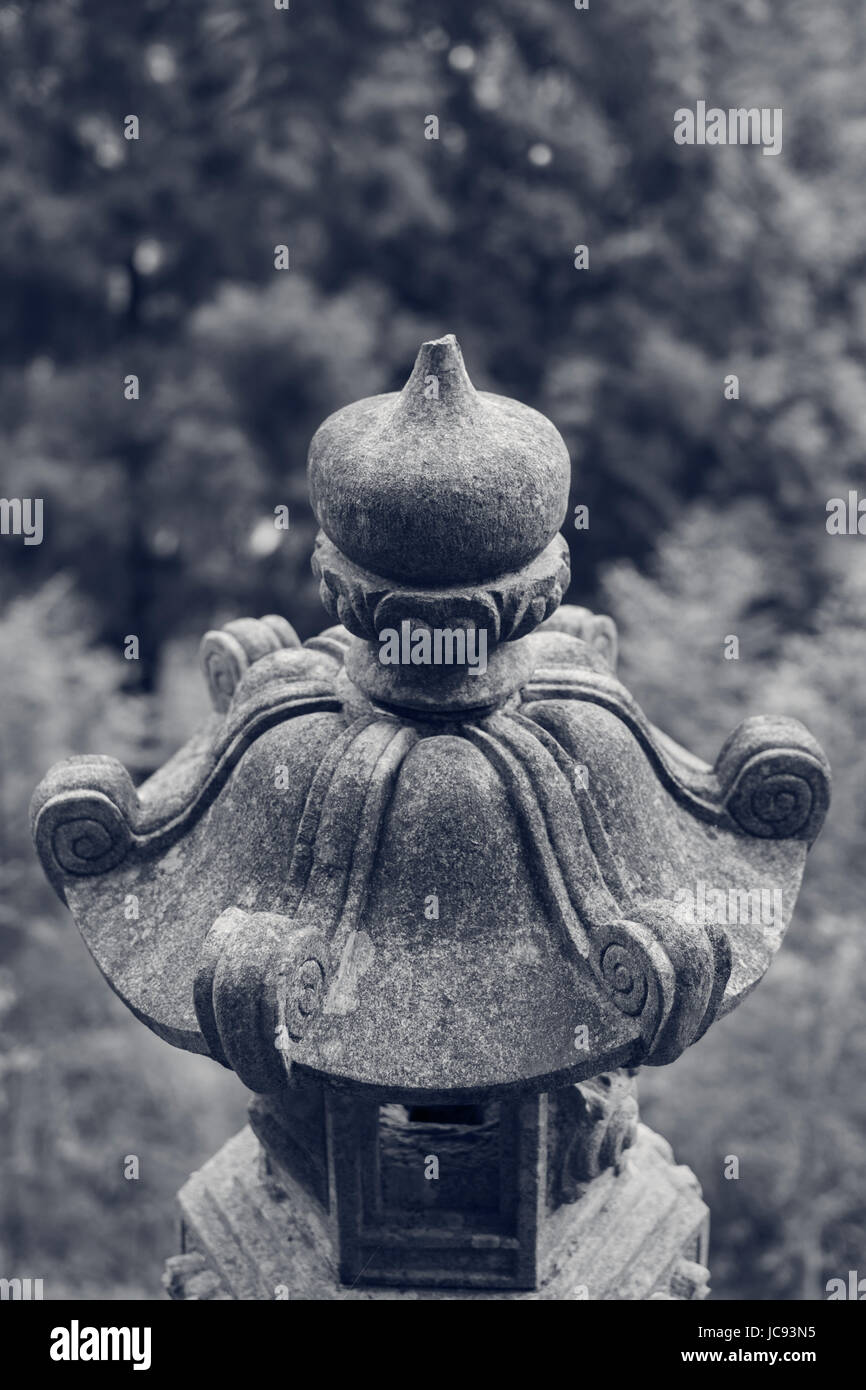 Traditional asian stone lantern in garden Stock Photo - Alamy