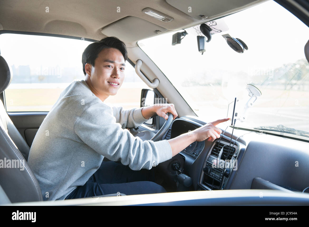 Smiling driver touching navigation in a truck Stock Photo - Alamy