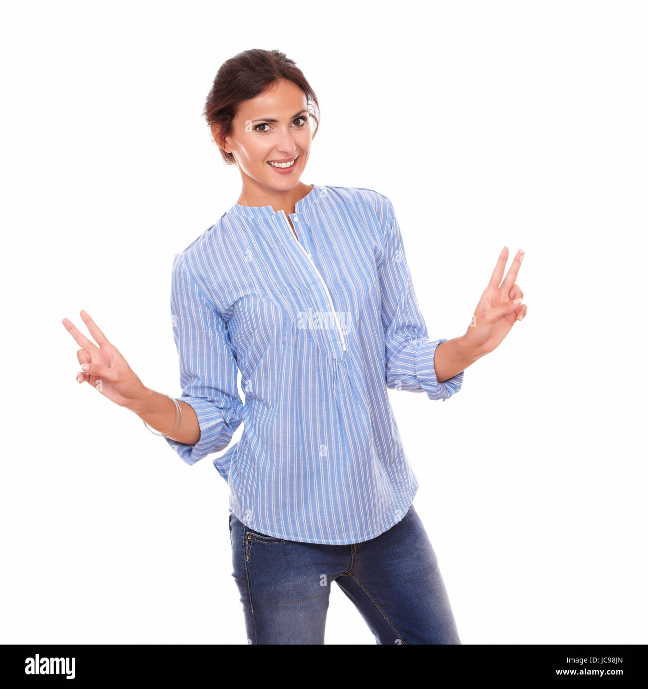 Portrait of charming 30s brunette on blue blouse with winning sign and ...