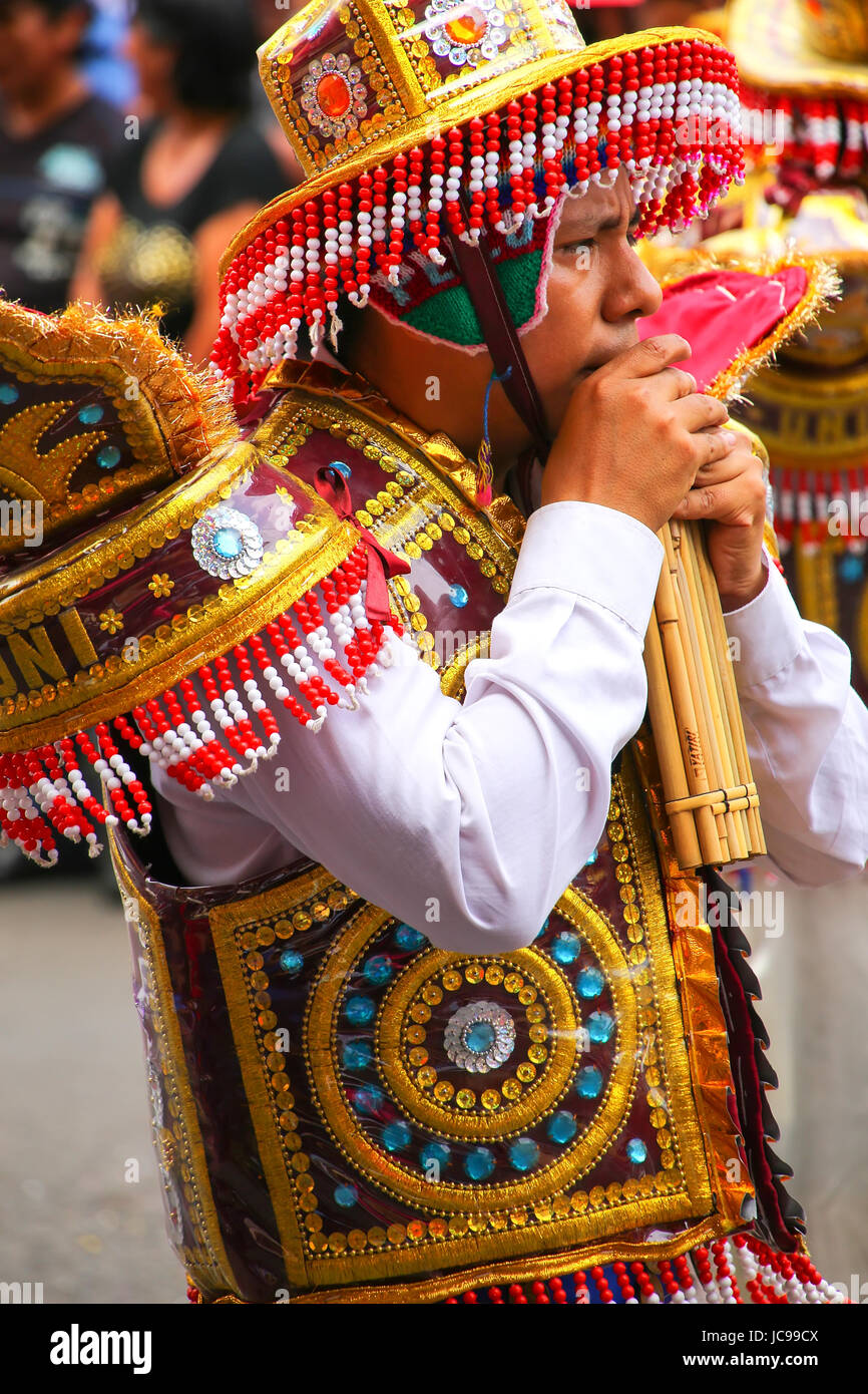 Local man playing flute during Festival of the Virgin de la Candelaria ...