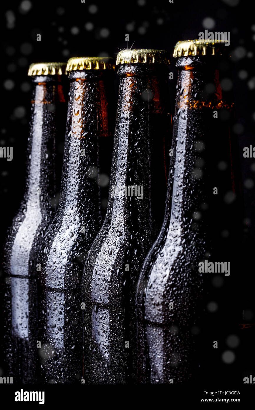 Bottles of beer on a black background Stock Photo - Alamy