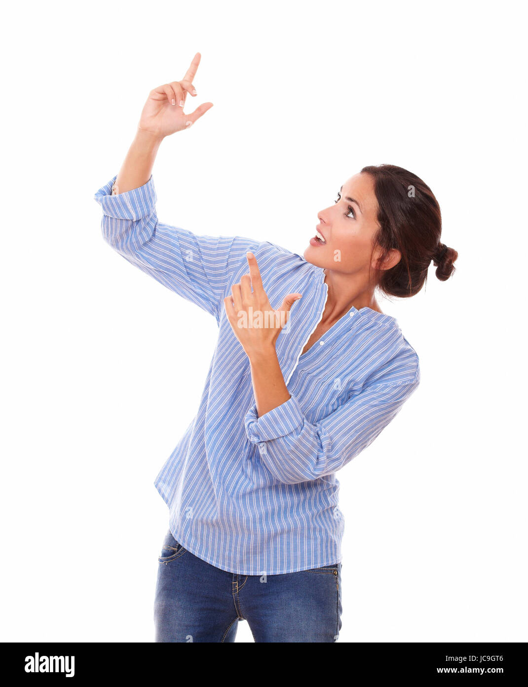 Portrait of hispanic woman on blue blouse pointing up her arms while ...
