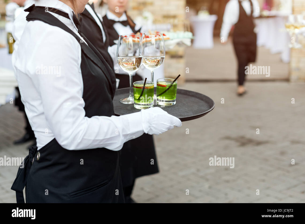 Professional male waiter in uniform serving champagne hi-res stock ...