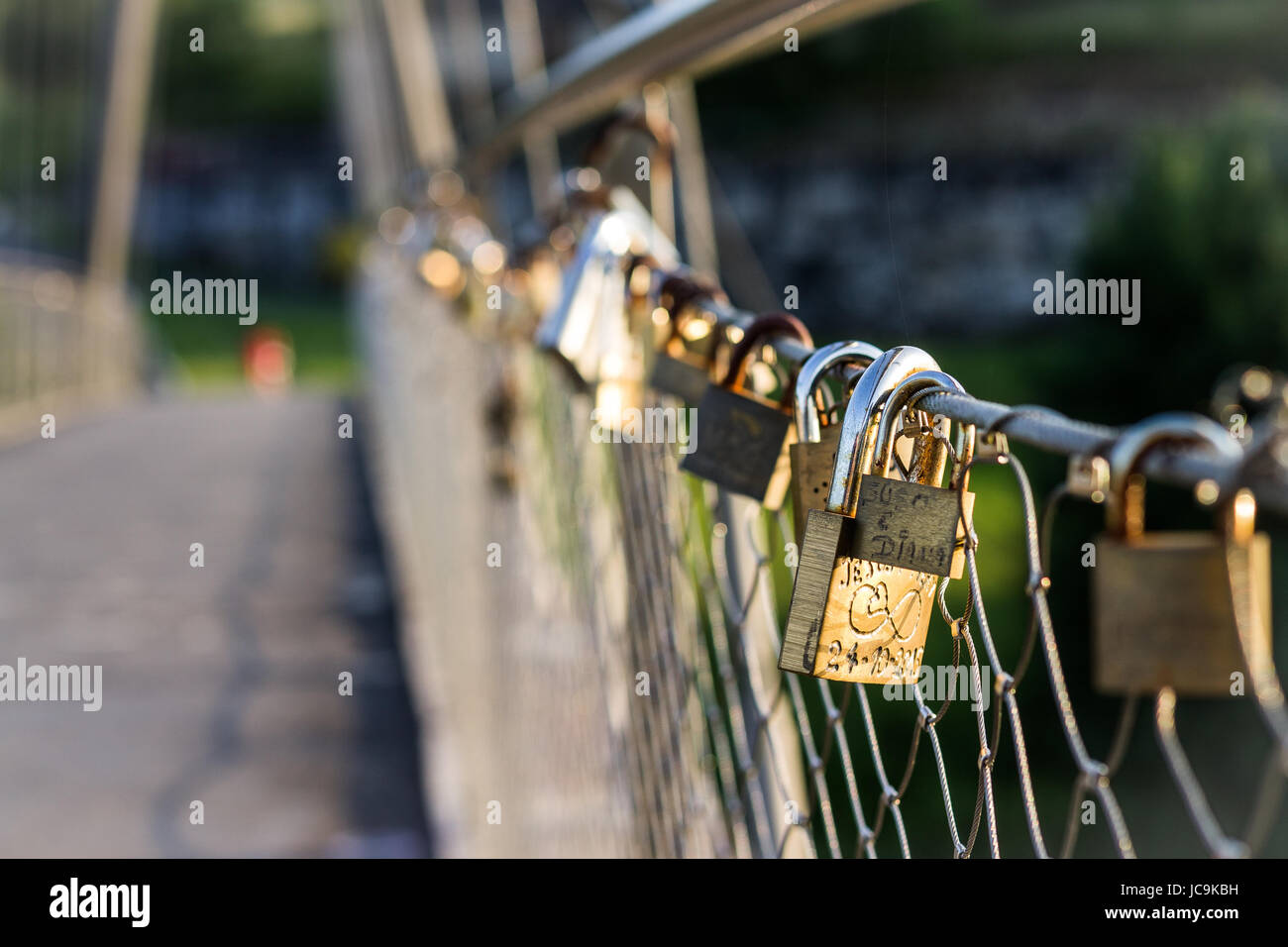 Padlocks on a bridge from people in love Stock Photo - Alamy