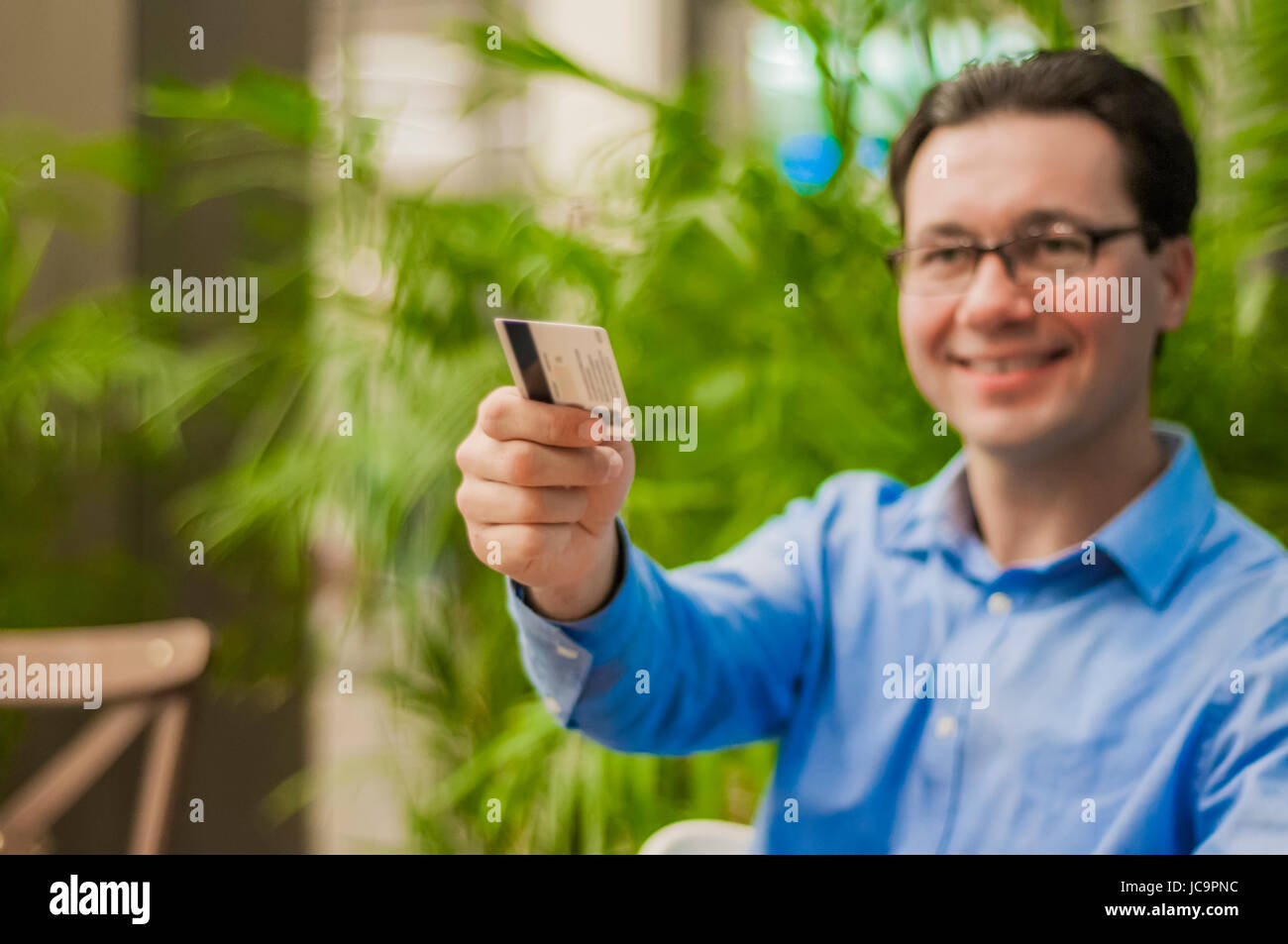 Customer paying bill at the restaurant with his credit card. Hands of ...