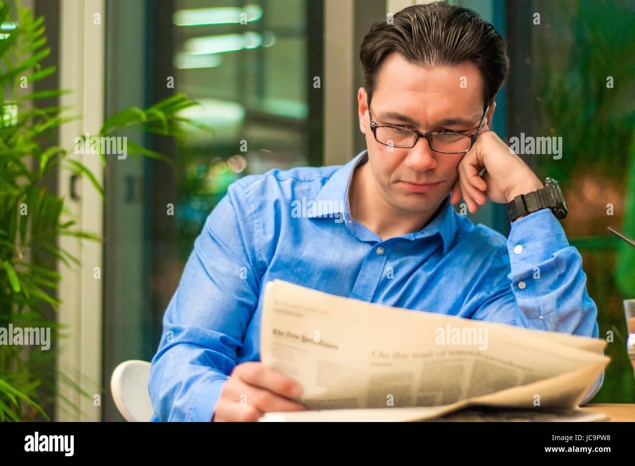 Reading open newspaper financial hi-res stock photography and images ...