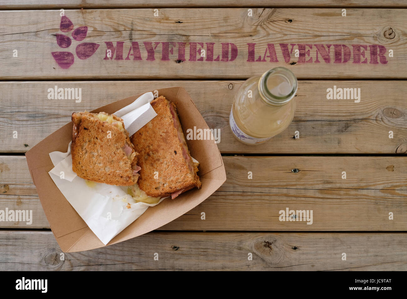 Ham and cheese toastie and lavender lemonade on the wooden table ...